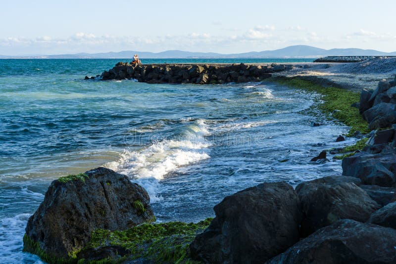 Holidaymakers on a Stone Spit in the Sea. Stock Photo - Image of ...