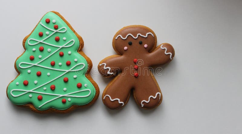 Gingerbread Man and Pine Tree Cookies with Decorative Icing on White ...