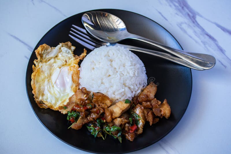 Holy Basil Rice with Crispy Pork and Fried Egg in Black Dish Stock ...