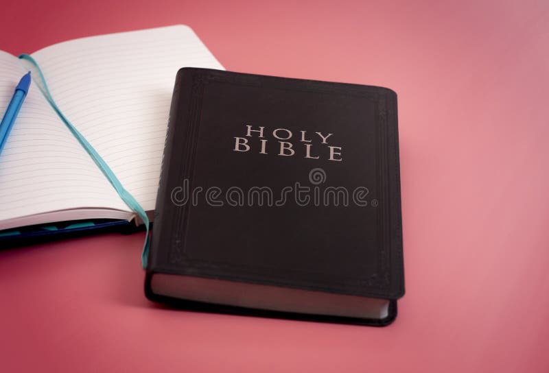 The Holy Bible with a Notebook To Study on a Bright Pink Background ...