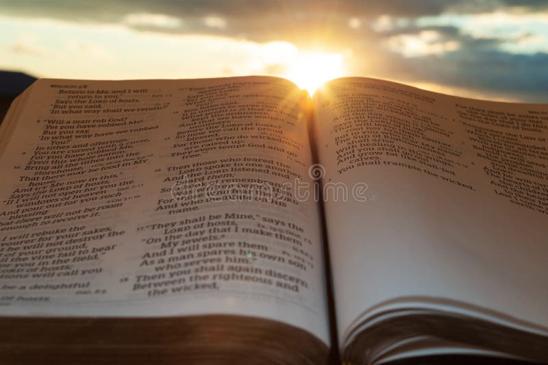 Holy Bible Open at Sunset with Highlight on Malachi 4:2. Background ...