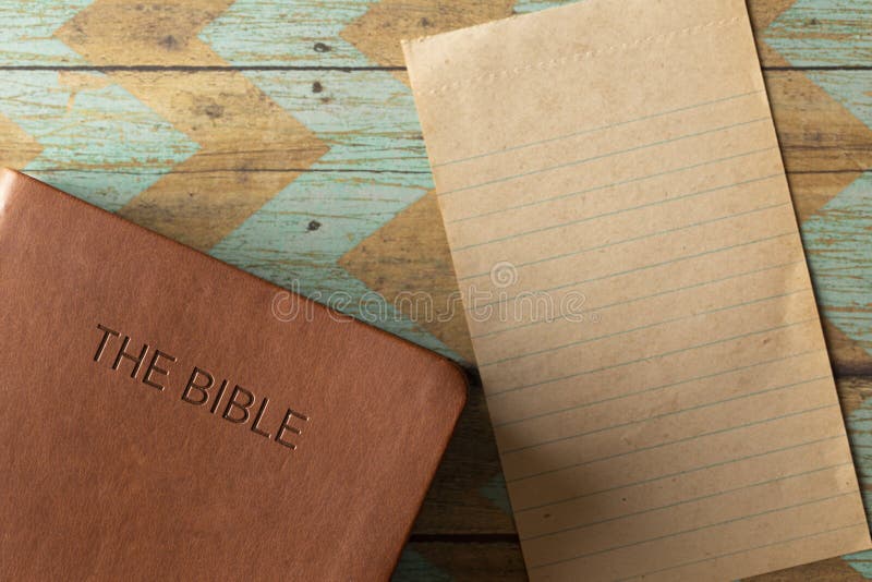 Holy Bible on a Rustic Wooden Table with a Blank Piece of Antique Paper ...