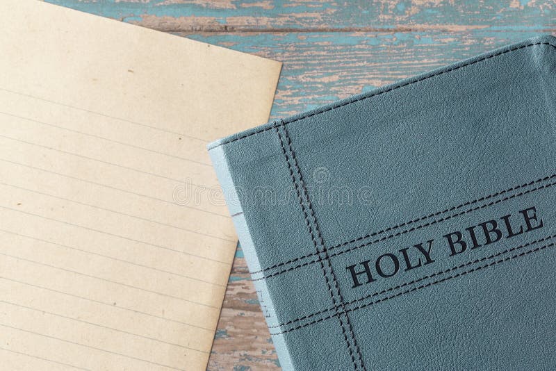 Holy Bible on a Rustic Wooden Table with a Blank Piece of Antique Paper ...
