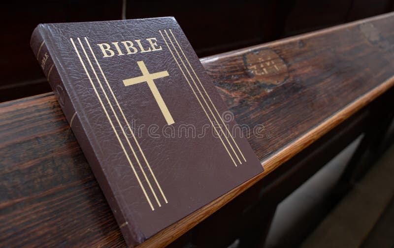 The Holy Bible on the Table of a Prayer Bench in the Church, Close Up ...