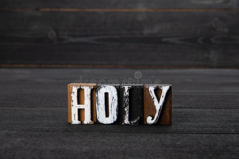 Holy. Text from Blocks on a Wooden Texture Background Stock Image ...