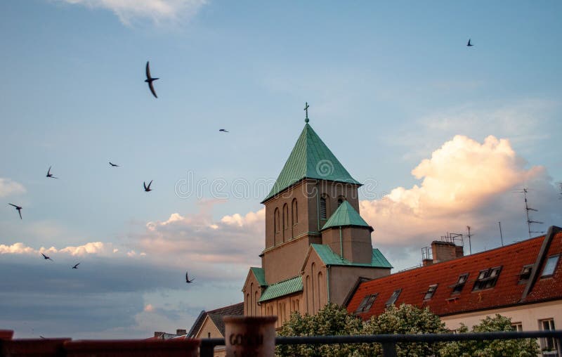 Holy Trinity Catholic Church with Birds Flying in the Blue Sky Stock ...