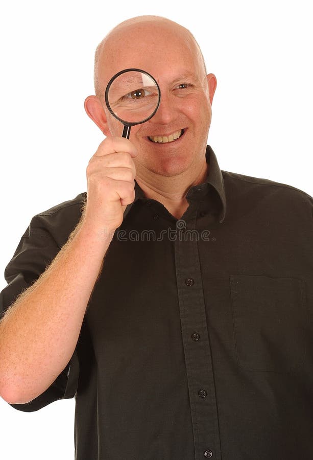 Hombre con la lupa imagen de archivo. Imagen de tenencia - 26363475
