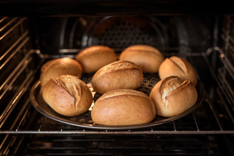 Home baked bread in oven stock photo. Image of oven, baking - 66820238