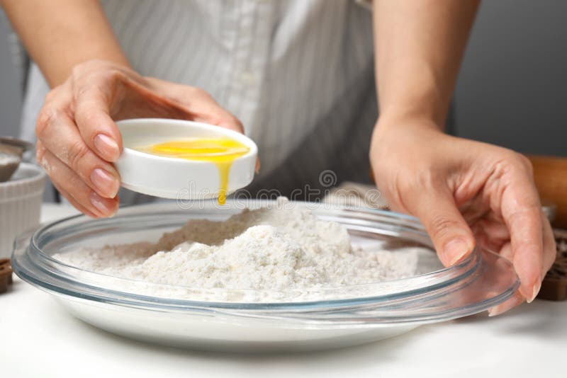 Home Baking. Woman Adding Egg Yolk To Flour, Closeup Stock Photo ...
