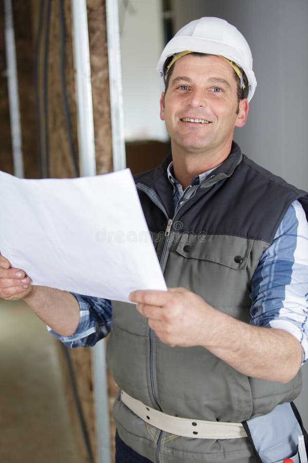 Home Builder Looks at Plans for New Home Stock Photo - Image of review ...