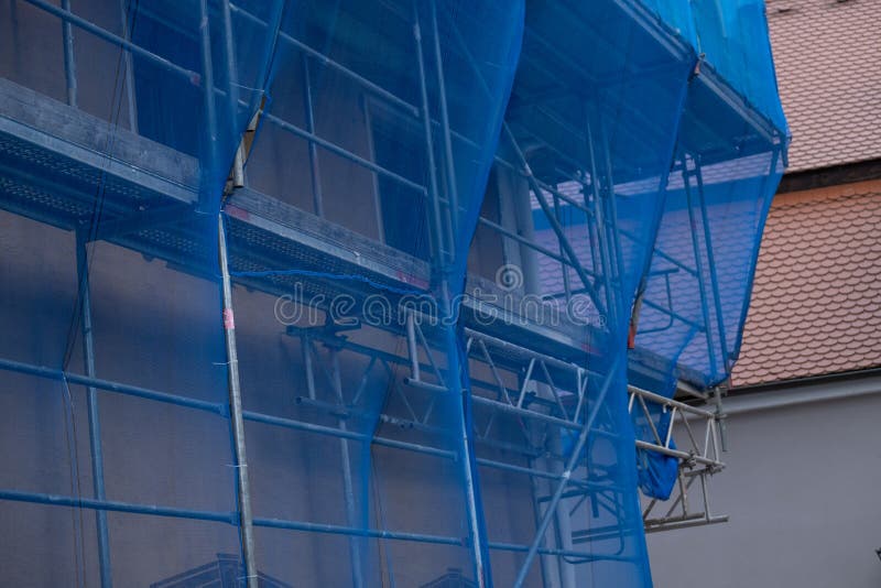 Home Construction. Scaffolding in a Protective Blue Grid. Building Work ...