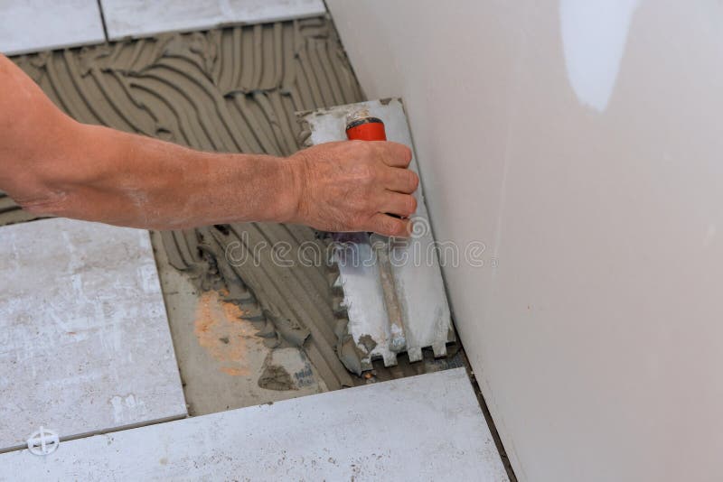 Master Puts Adhesive Base Over Floor for Ceramic Tile Stock Image ...