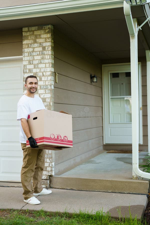 Home Delivery Service. Deliveryman with Boxes Standing by the House ...