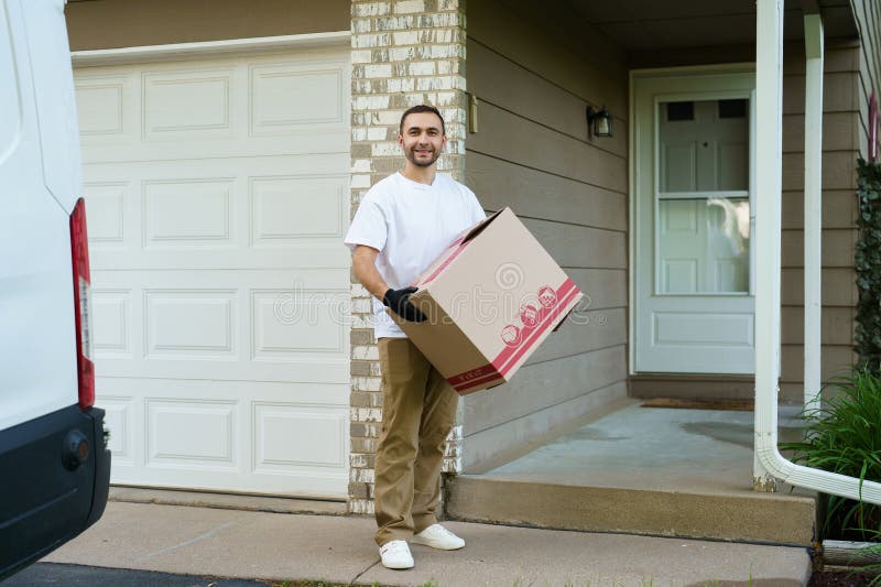 Home Delivery Service. Deliveryman with Boxes Standing by the House ...