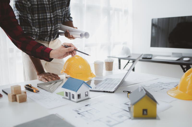 The Home Design Architects are Reviewing the House Plan Draft, the Project Commissioned by the ...