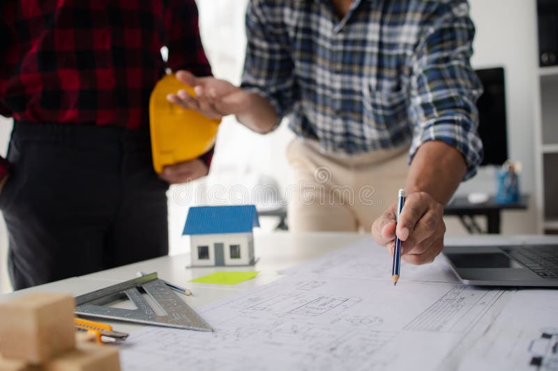 The Home Design Architects are Reviewing the House Plan Draft, the ...