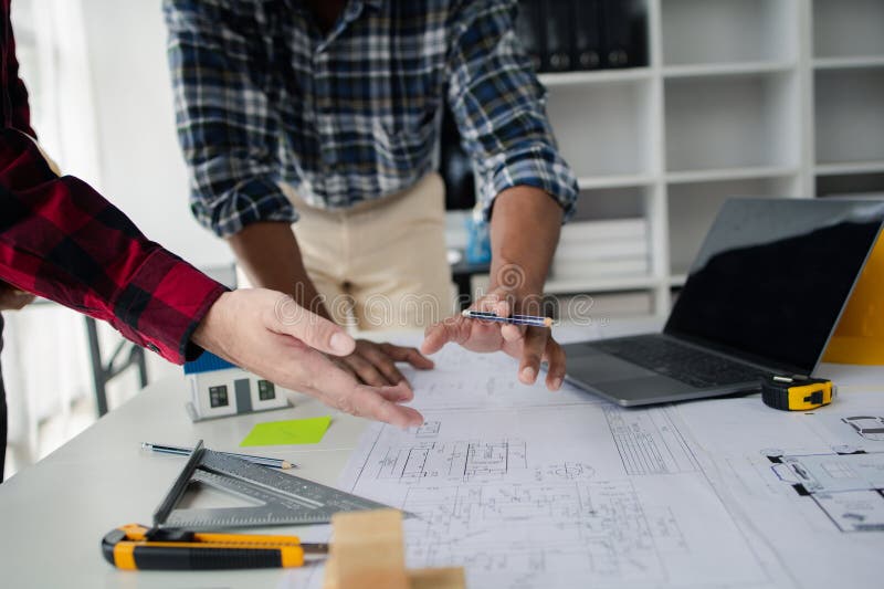 The Home Design Architects are Reviewing the House Plan Draft, the Project Commissioned by the ...