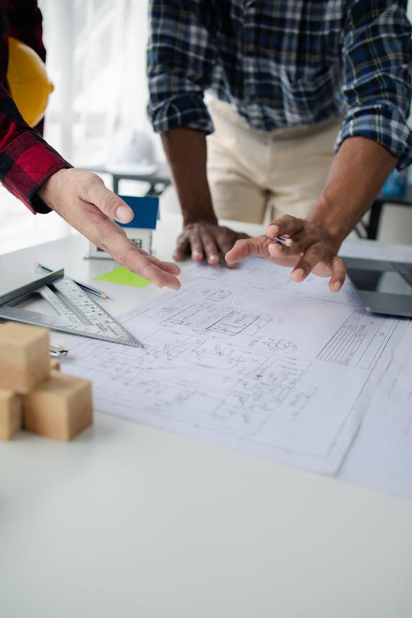 The Home Design Architects are Reviewing the House Plan Draft, the Project Commissioned by the ...