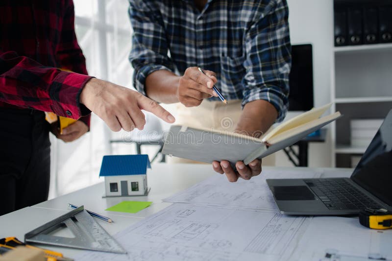 The Home Design Architects are Reviewing the House Plan Draft, the ...