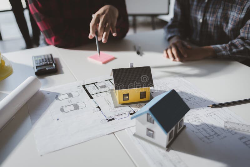 The Home Design Architects are Reviewing the House Plan Draft, the ...