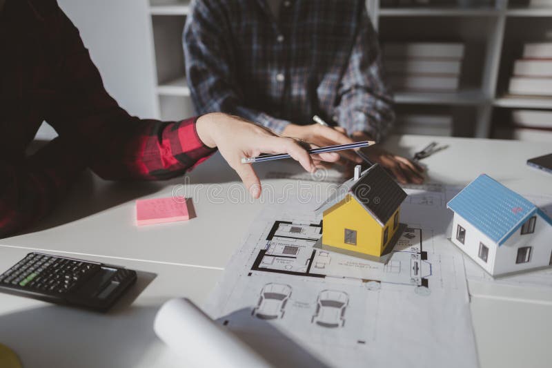 The Home Design Architects are Reviewing the House Plan Draft, the ...