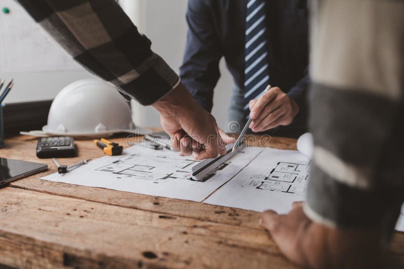 The Home Design Architects are Reviewing the House Plan Draft, the ...