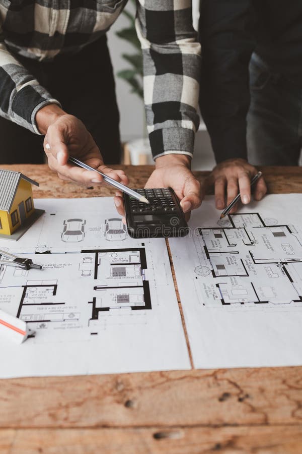 The Home Design Architects are Reviewing the House Plan Draft, the ...