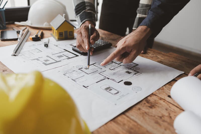 The Home Design Architects are Reviewing the House Plan Draft, the Project Commissioned by the ...