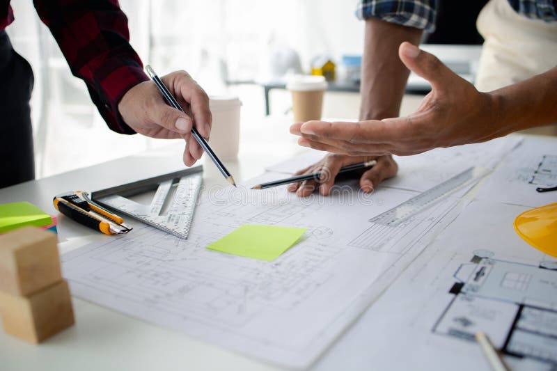 The Home Design Architects are Reviewing the House Plan Draft, the Project Commissioned by the ...