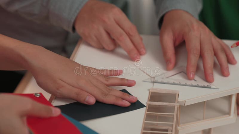 Home Designer and Client Choosing Color Sample for House. Variegated ...