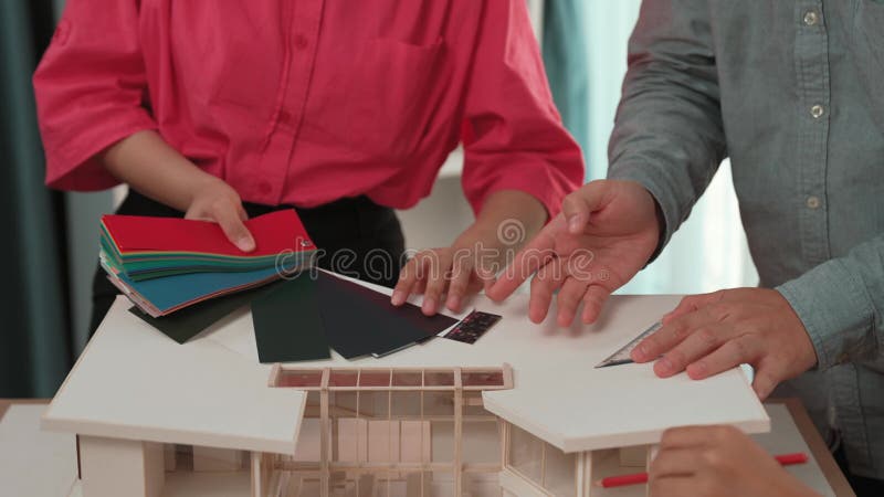 Home Designer and Client Choosing Color Sample for House. Variegated ...