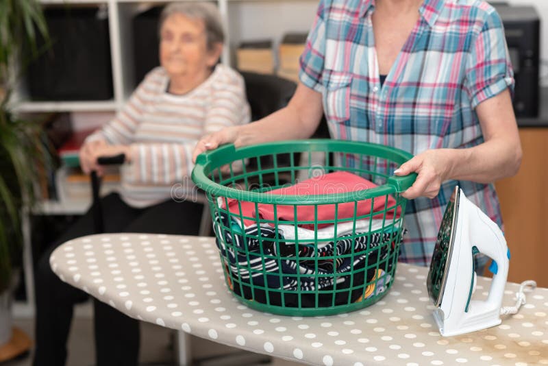 Senior Couple Enjoying Meal Together at Home with Home Help Stock Image ...