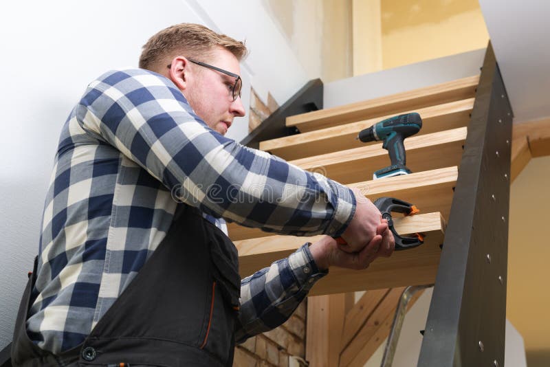 Home Improvement Handyman Building Staircase in a Natural Light Stock ...