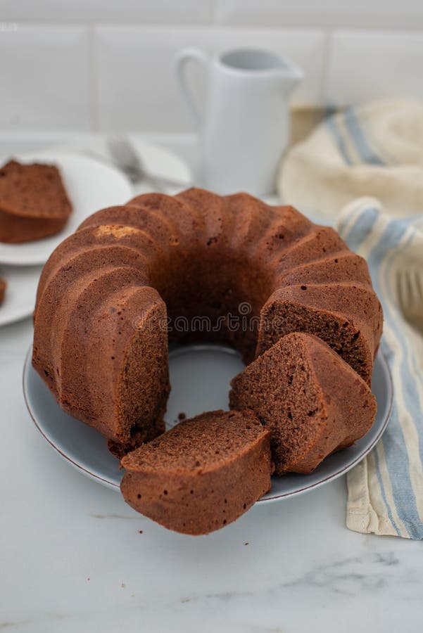 Home Made Chocolate Bundt Cake and a Slice on a Plate Stock Image ...