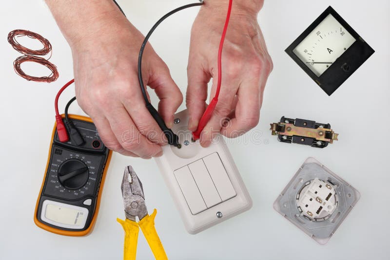 An Home Master Checks the Isolation of the Light Switch Using a ...