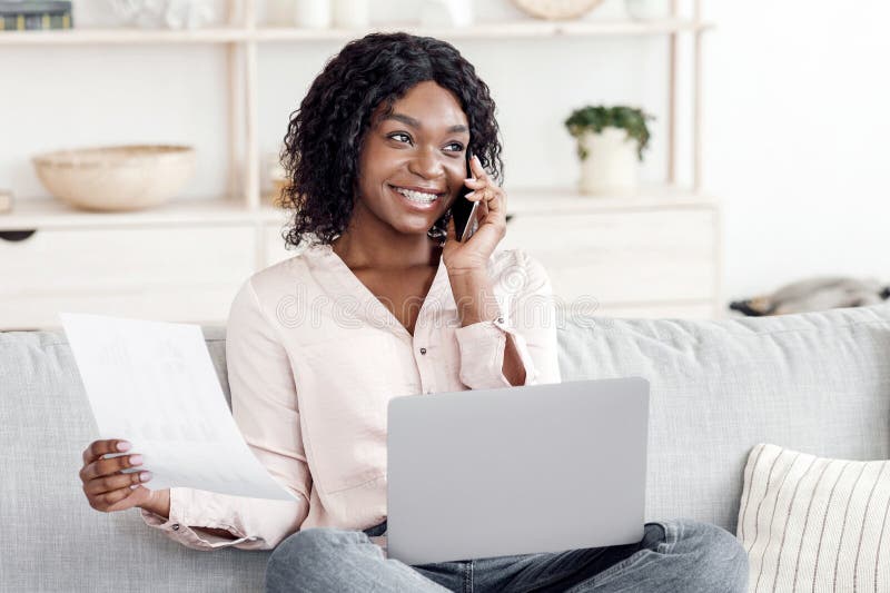 Home Office. Black Woman Checking Documents and Talking on Cellphone at ...