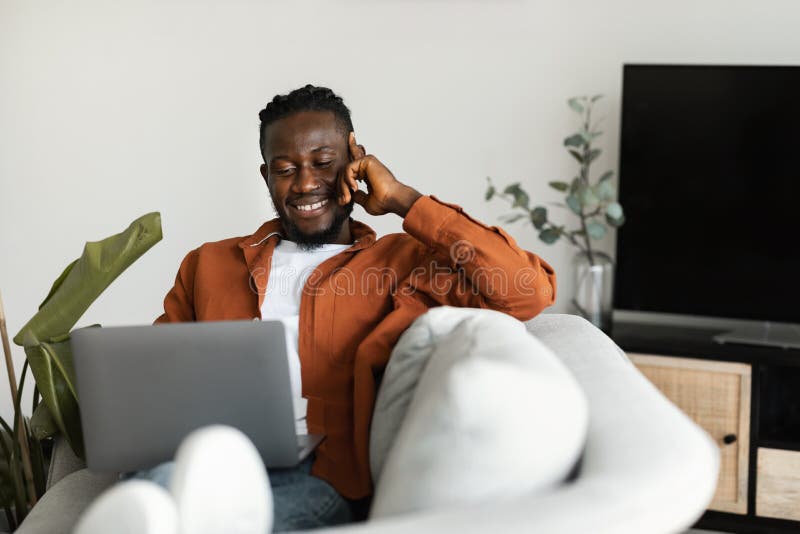 Home Office Concept. Happy Black Man Working on Laptop while Sitting on ...