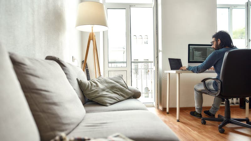 Home Office. Rear View of Young Man, Software Developer Writing Code on ... Home Office. Rear View of Young Man, Software Developer Writing Code on ...