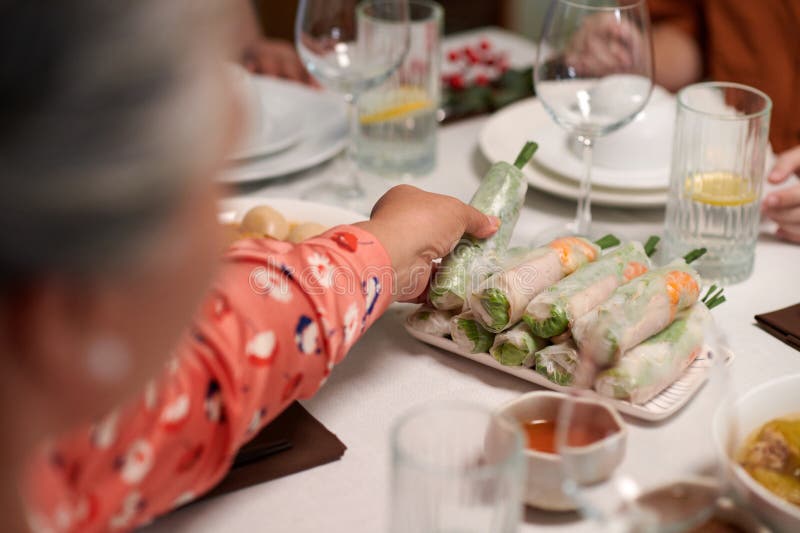 Party Guest Taking Spring Roll Stock Photo - Image of home, woman ...
