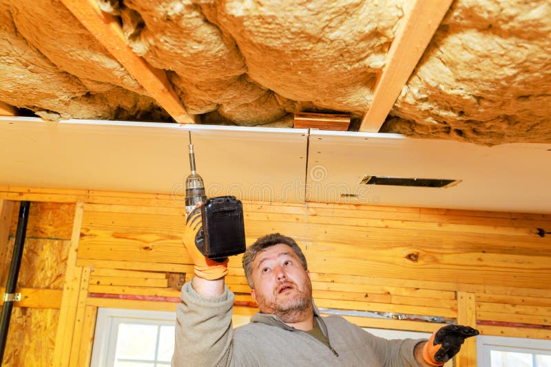Home Renovation Project in Progress with Worker Installing Ceiling ...