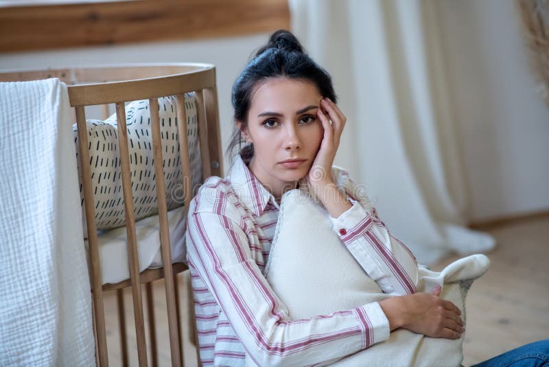 Sad Young Woman Hugging Pillow, Leaning on Cot with Propped Head Stock ... Sad Young Woman Hugging Pillow, Leaning on Cot with Propped Head Stock ...
