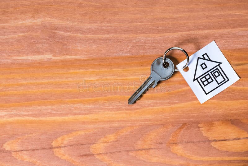Home Symbol Token Along with Silver Key on Wooden Surface Stock Image ...