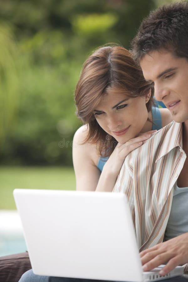 Home Tech Couple Looking at Laptop in Garden Stock Image - Image of ...