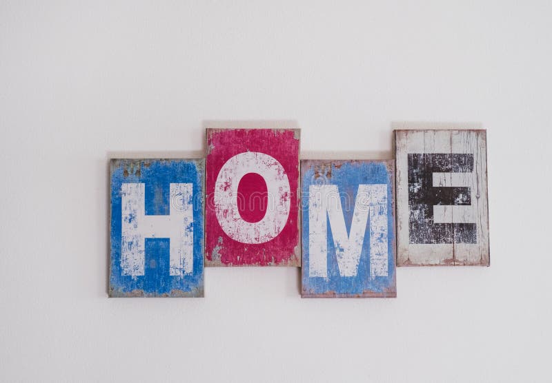 Home Wood Decorative Lettering Hanging on a White Wall Stock Photo ...