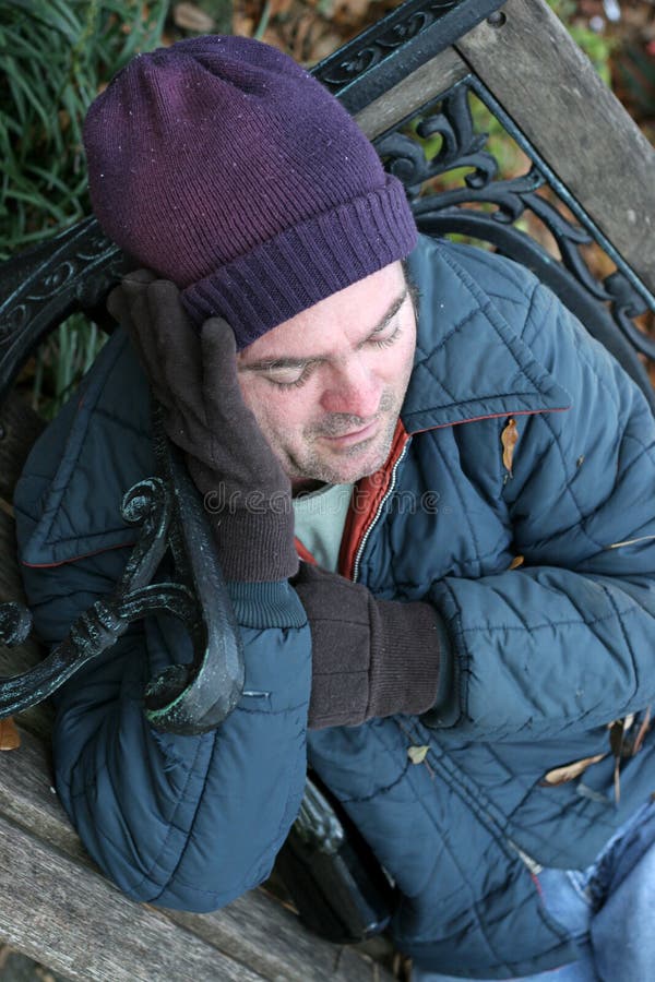 Homeless Man Keeps Warm stock photo. Image of bench, beard - 3921956