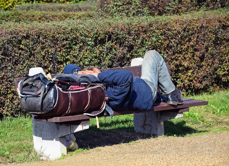 Homeless Man is Sleeping on a Bench Stock Photo - Image of jacket, wood ...