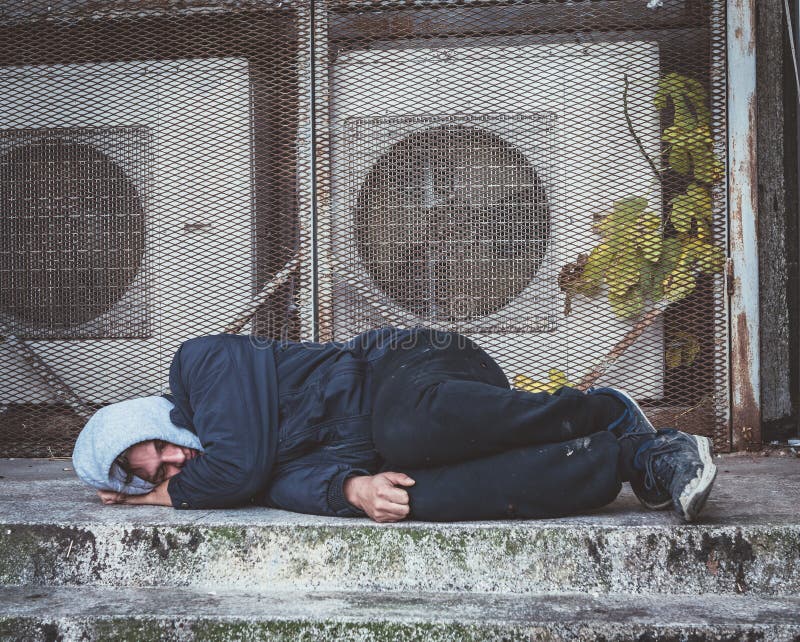 Homeless Man Sleeps on Concrete Steps in the City Stock Photo - Image ...