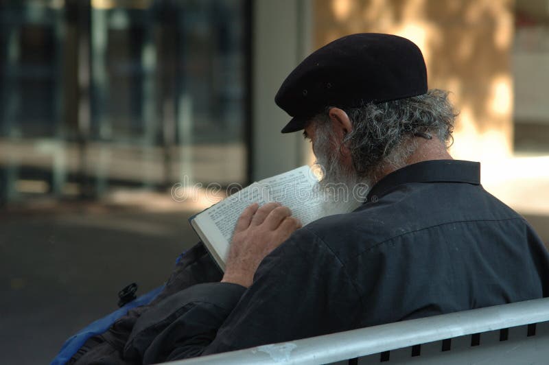 Homeless reading the bible stock image. Image of bench - 278645