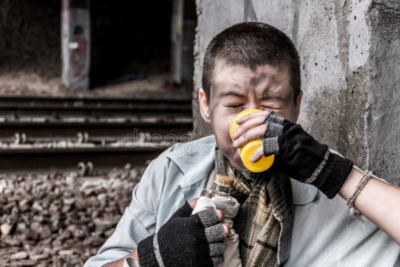 Homeless woman drinking stock photo. Image of gloves - 77450700