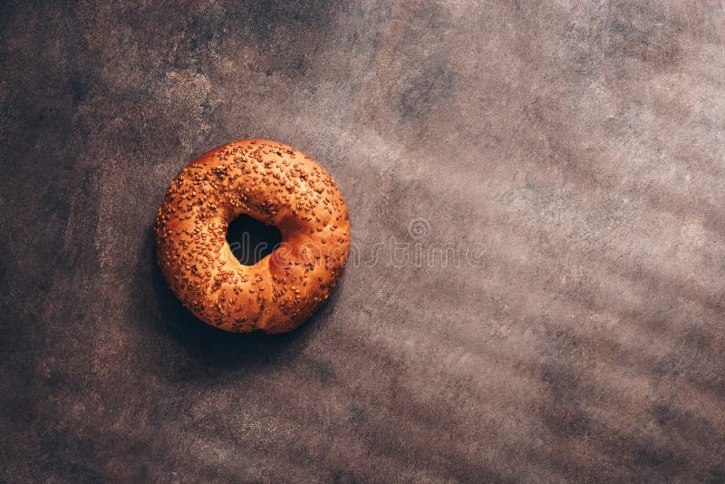Homemade Bagel with Sesame on a Dark Rustic Background with Shadows ...